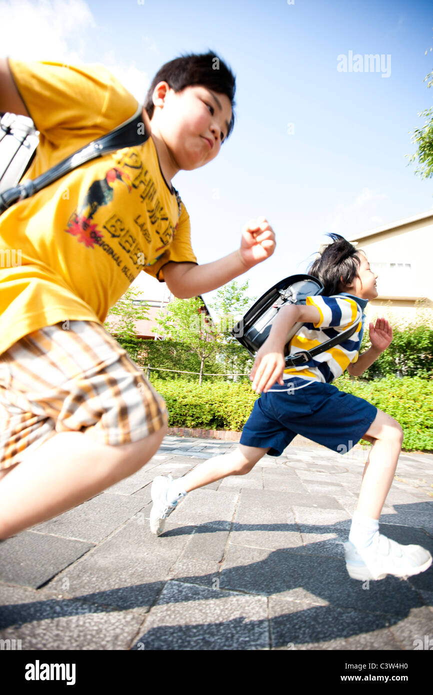 Elementary school boys running , Japan Stock Photo - Alamy