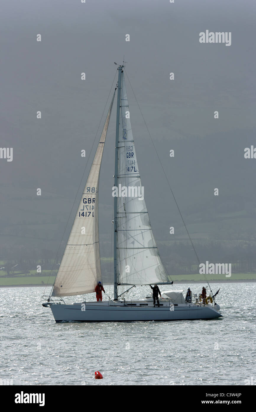 A yacht sailing on the Menai Straits off Beaumaris on the Isle of ...