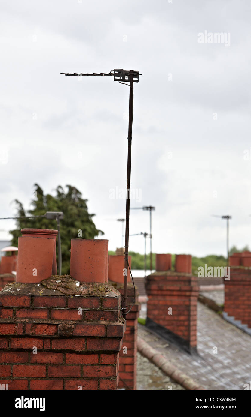 An analogue television aerial on the roof of a residential house. Most ...