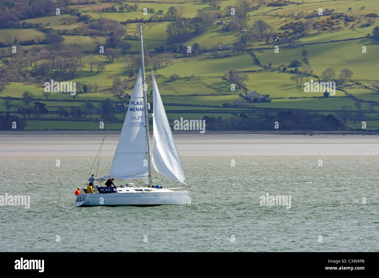 A yacht from the Plas Menai Sailing centre, sailing on the Menai ...