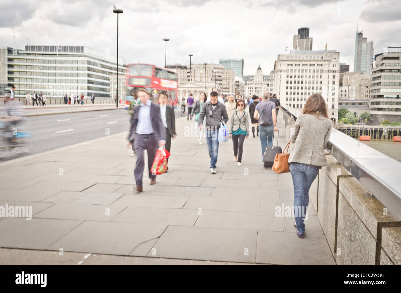 people walking over London Bridge blurred Stock Photo - Alamy