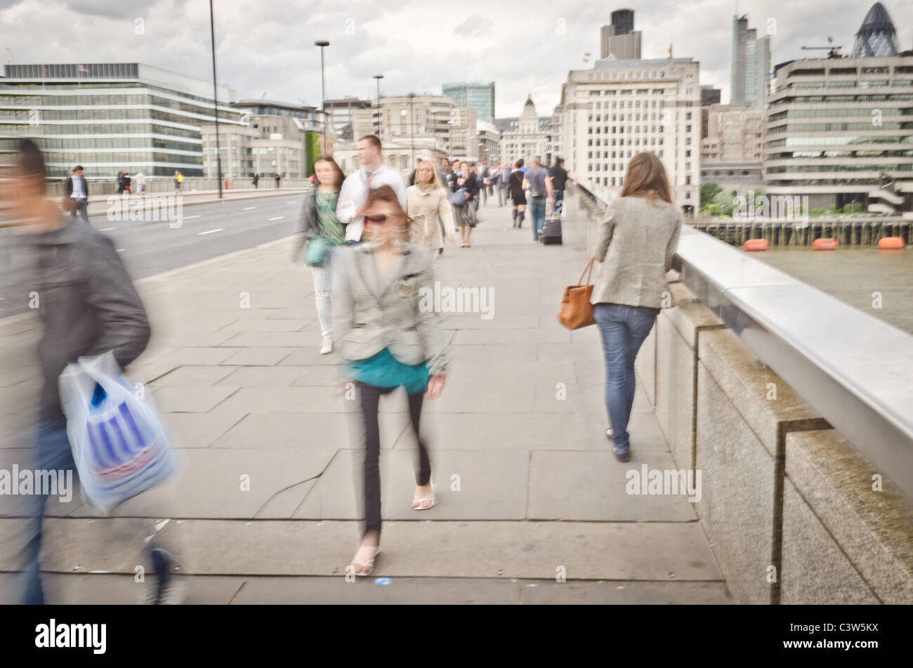 people walking over London Bridge Stock Photo - Alamy
