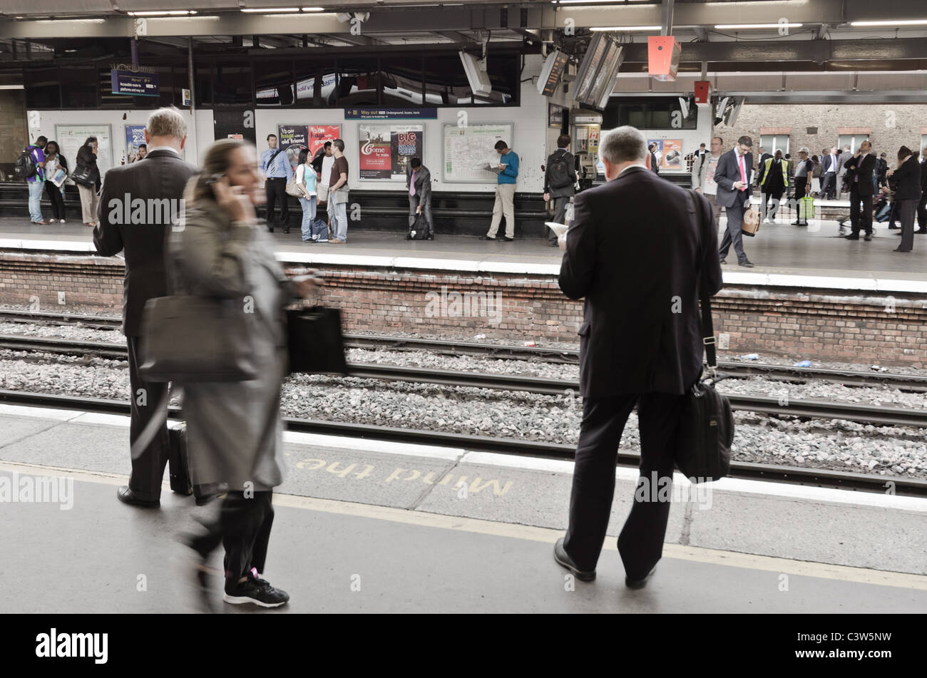Commuters on train station platform Stock Photo - Alamy