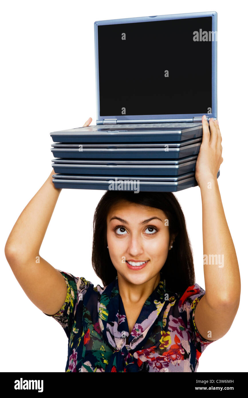 Confident woman carrying a stack of laptops isolated over white Stock ...
