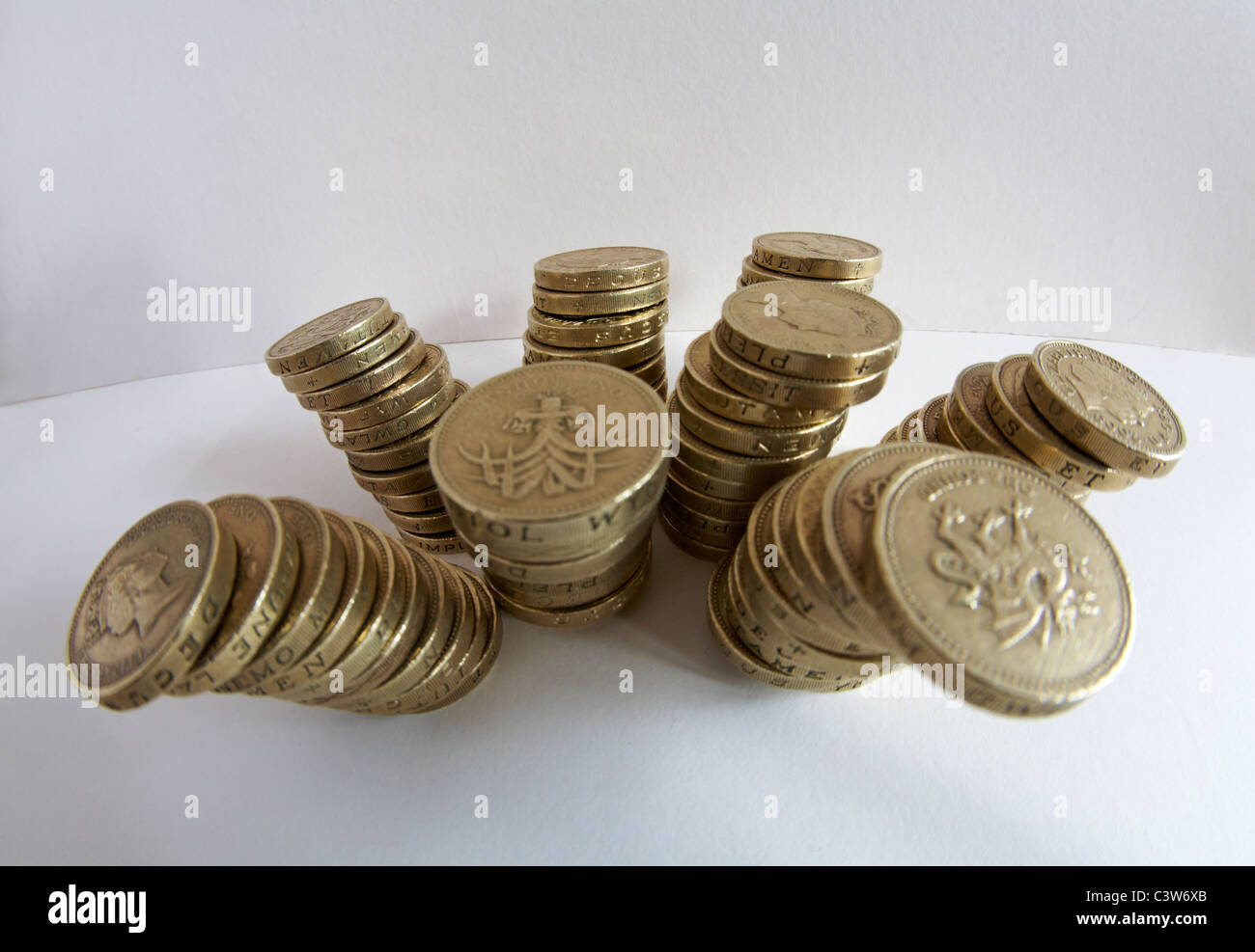 piles of one pound coins toppling - taken with fish eye lens Stock ...