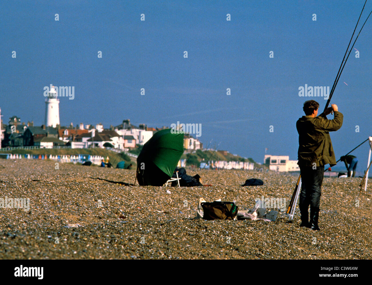 Fisherman preparing his rod on the beach at Southwold Suffolk Stock ...