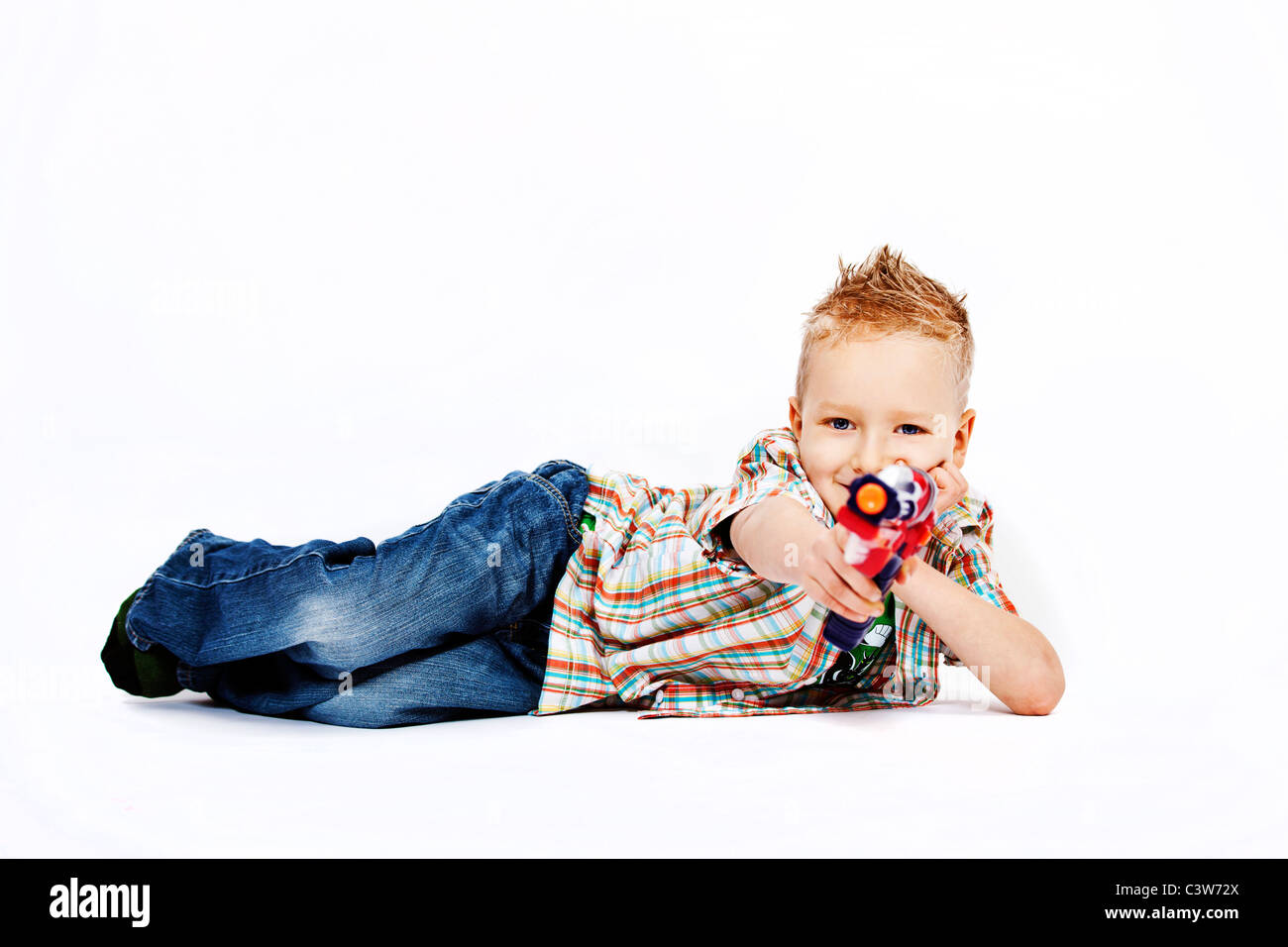 smiling young boy with his toy gun Stock Photo - Alamy