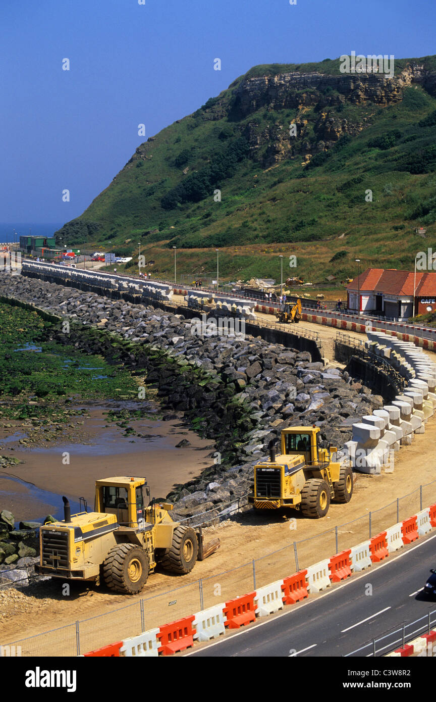 heavy machinery moving giant stone boulders building sea defences at ...