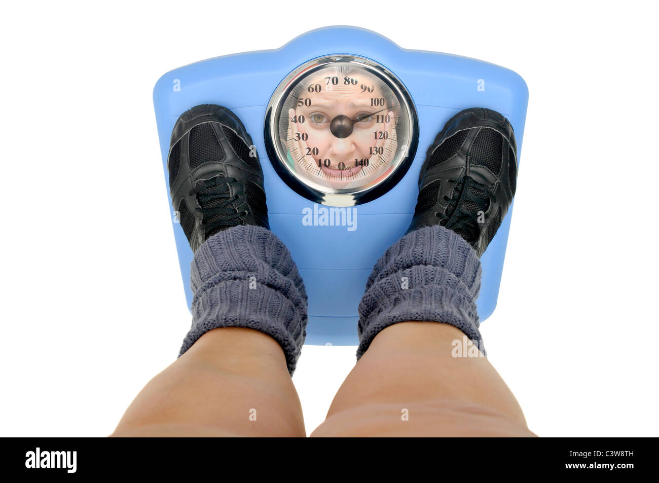 Weight scale with desperate woman's face reflecting isolated in white ...