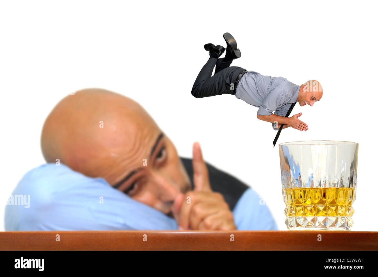 Businessman looking at himself diving into a glass of alcohol isolated ...
