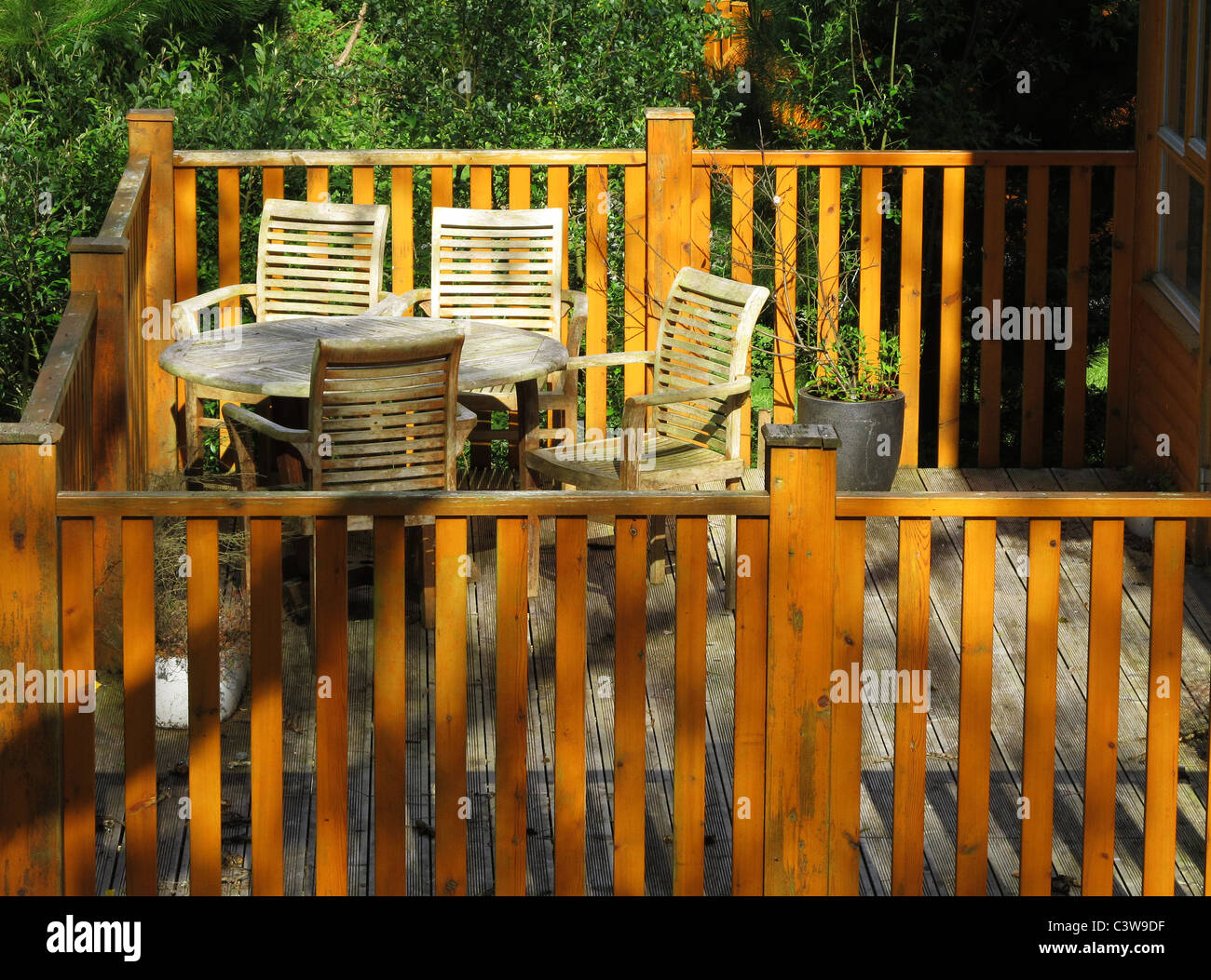Wooden terrace with table and few chairs on a sunny day Stock Photo - Alamy