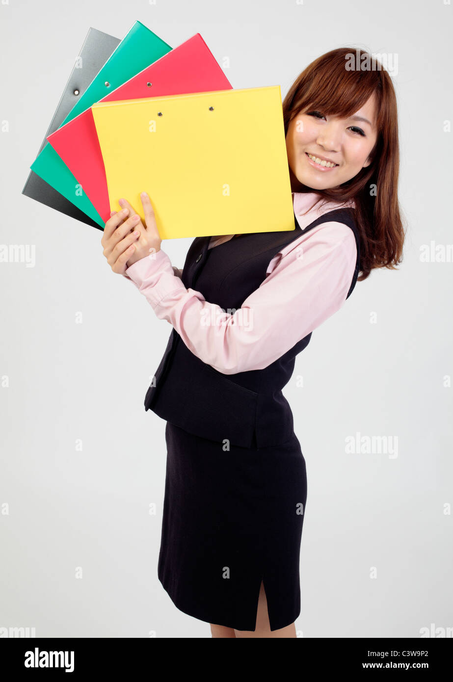 Office lady holds colorful files Stock Photo - Alamy