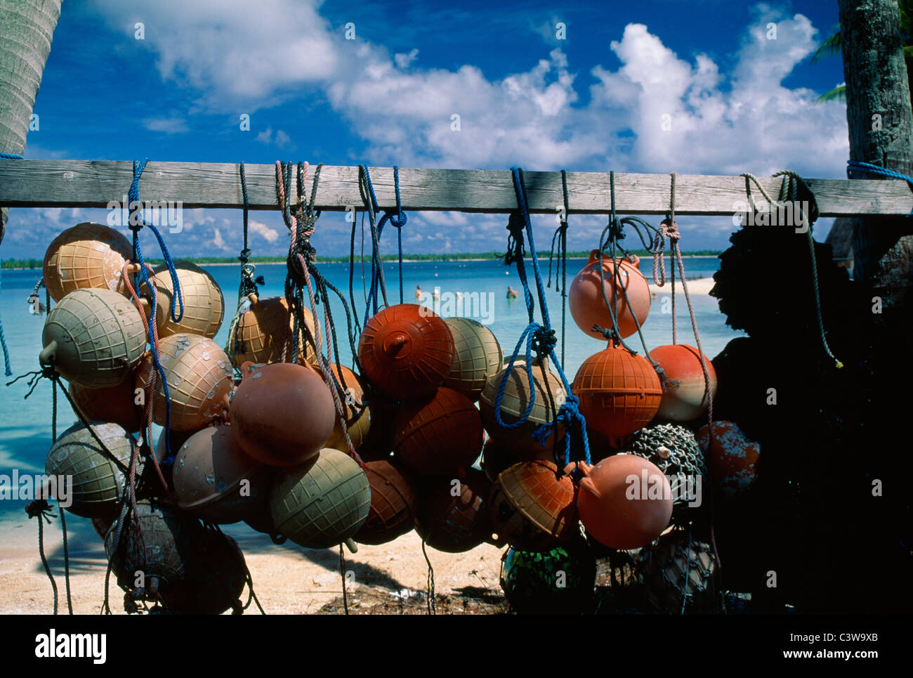 VARIETY OF FISHING FLOATS HANGING TO DRY ON BEACH AT TAKAPOTO ISLAND ...
