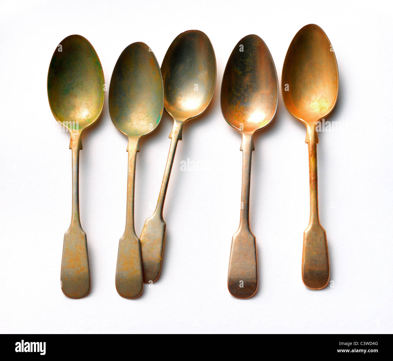 old used spoons on a white background Stock Photo - Alamy