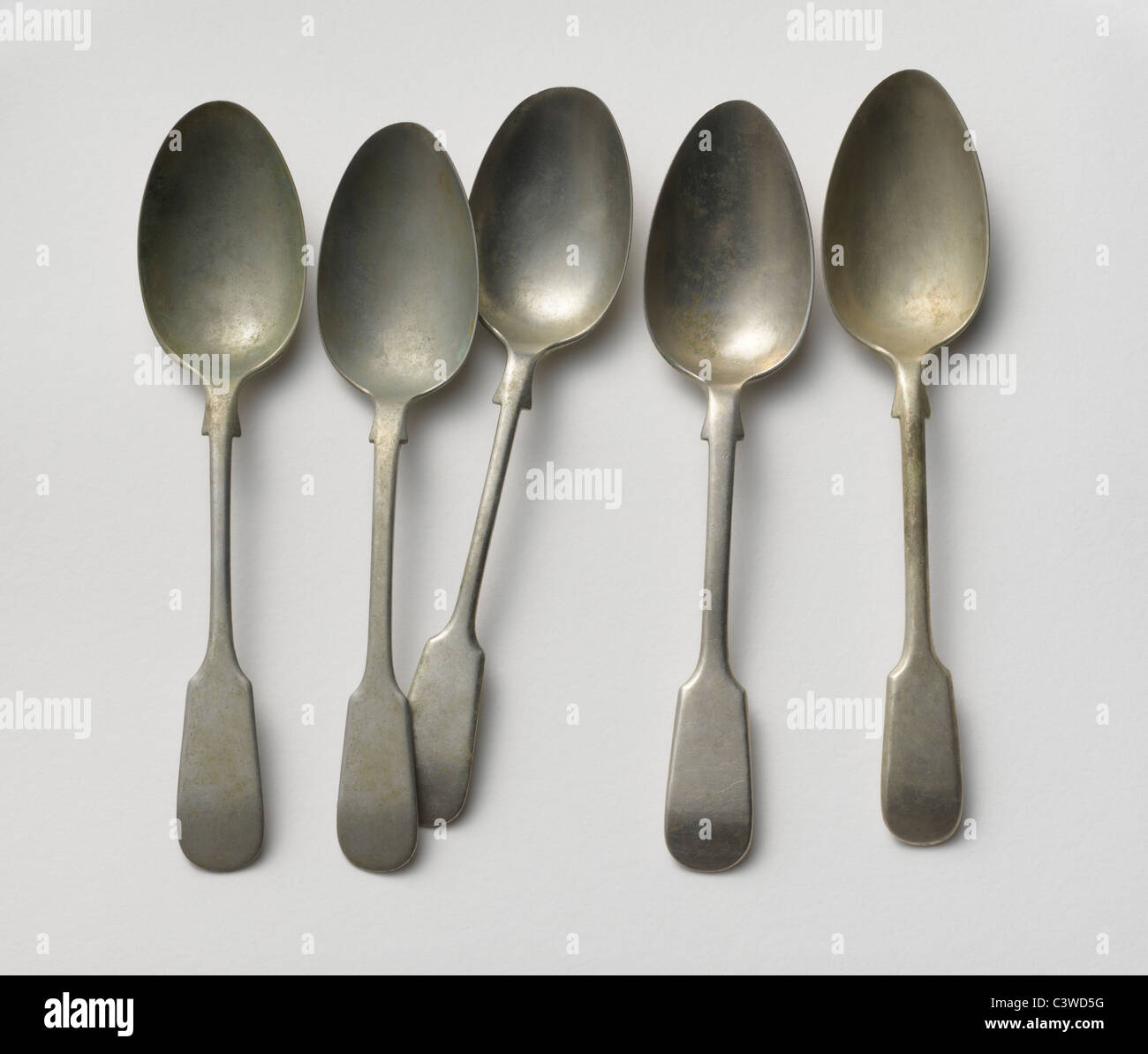 old used spoons on a white background Stock Photo - Alamy