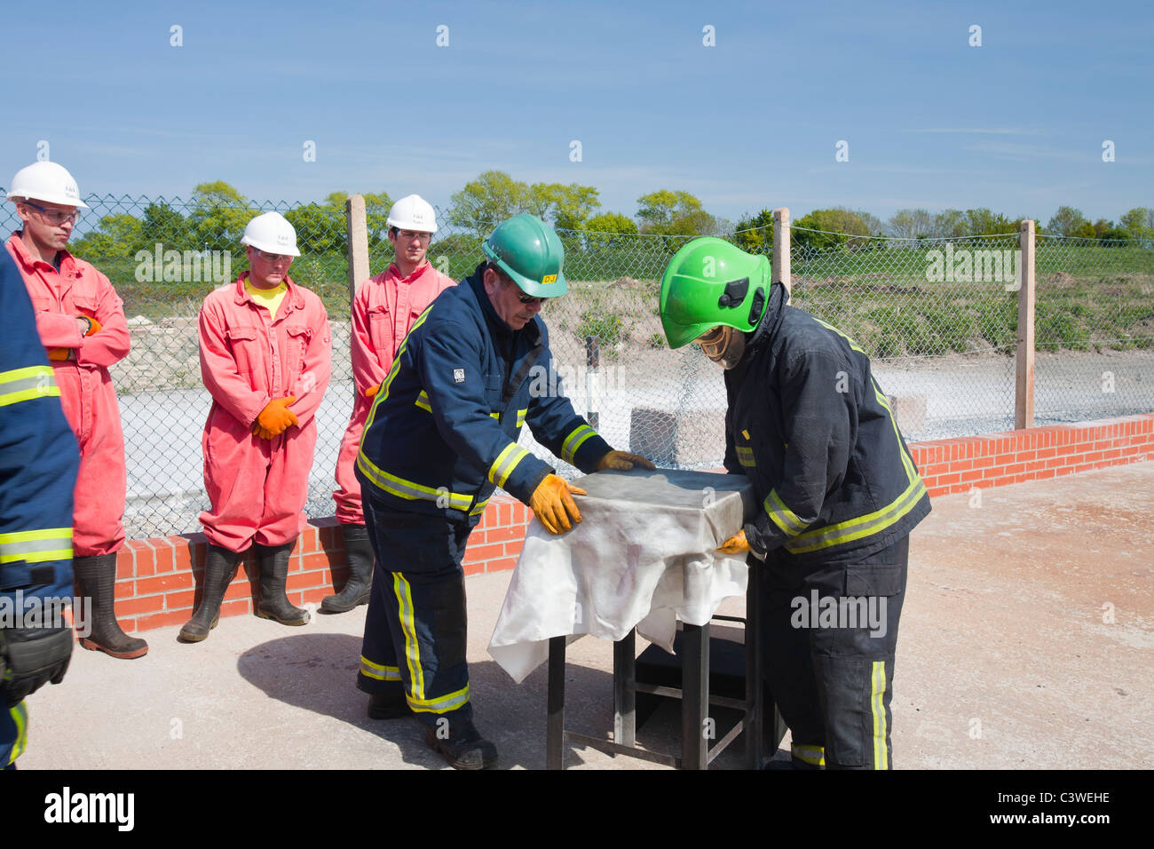 Workers in the offshore industry practice fire fighting as part of an ...