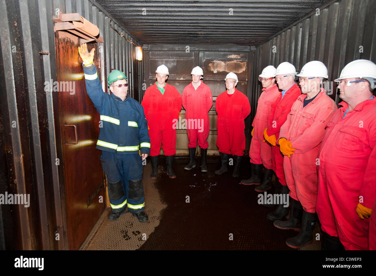 Workers in the offshore industry practice escaping from a smoke chamber ...