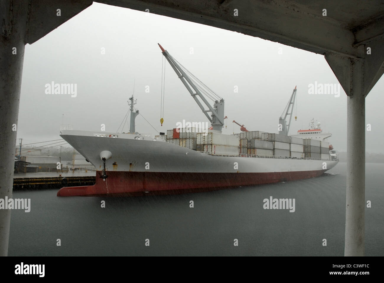 Huge container cargo ship heading for port. Cloudy sky background Stock ...