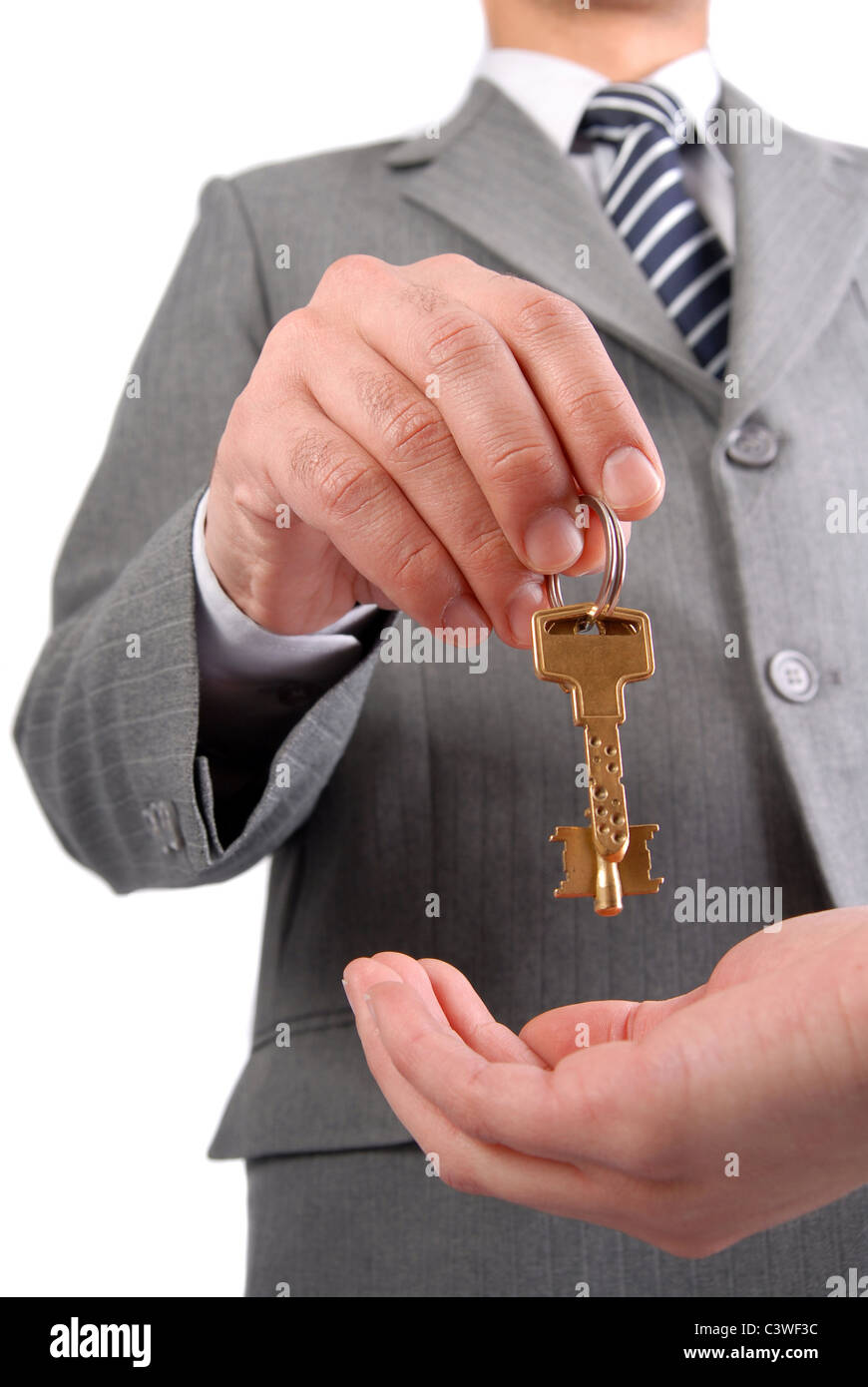 Businessman handing a key to success over a woman palm isolated on ...