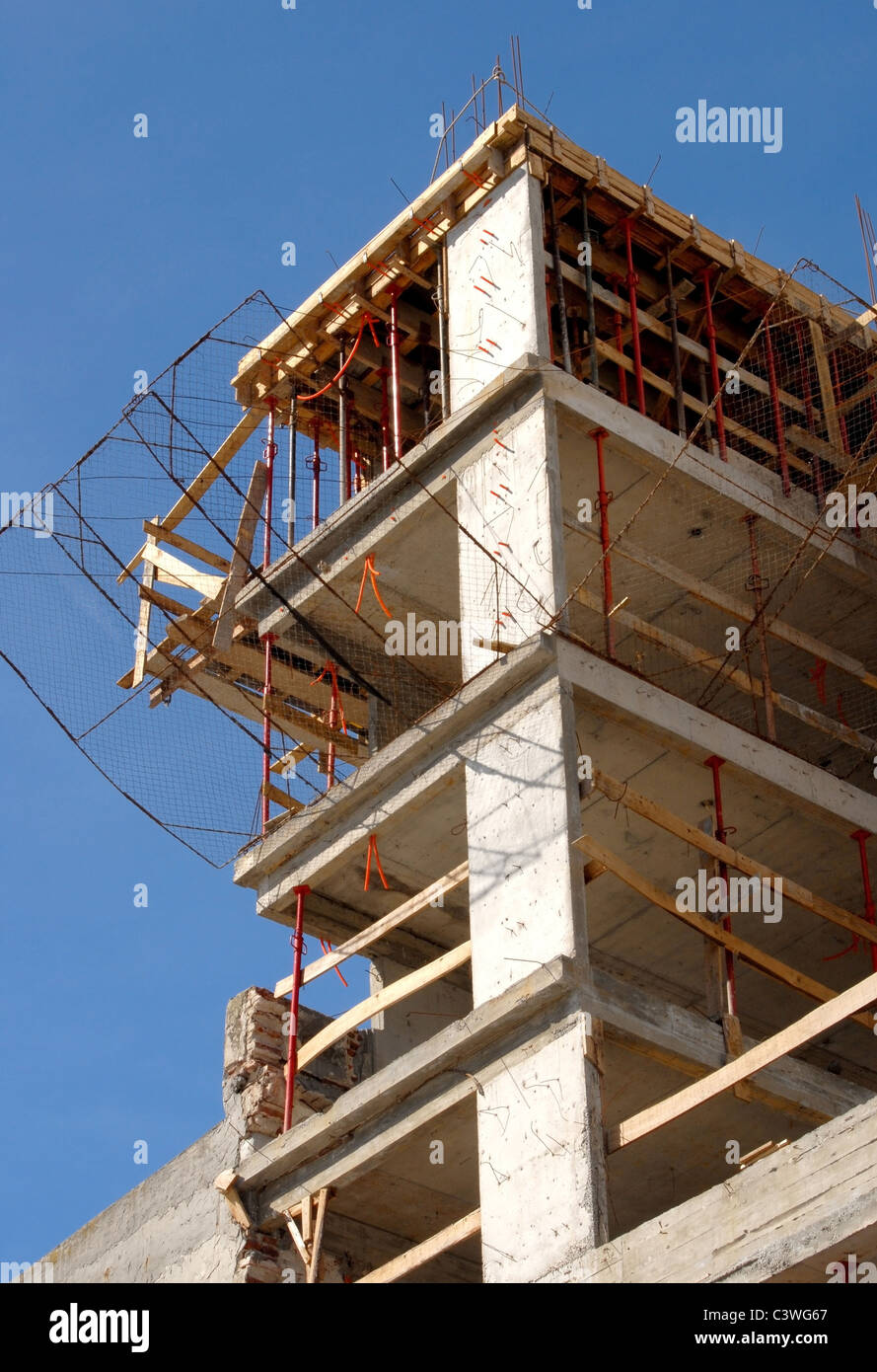 Detail of the upper part of a building under construction on a blue sky ...