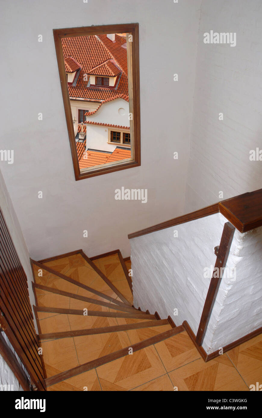 staircase with window with view to city roofs Stock Photo - Alamy