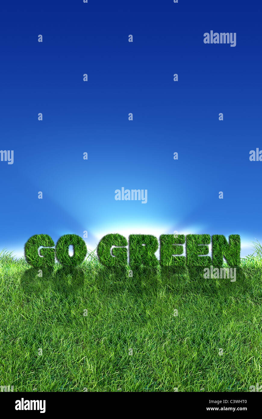 Textured go green sign over fresh grass. Clear blue sky background ...