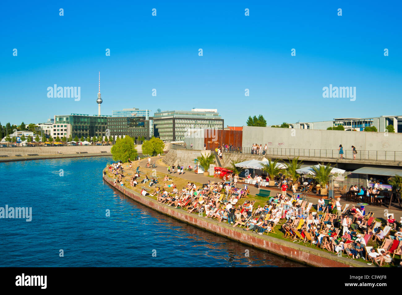 People sunbathing at beach club and bar at the banks of river Spree ...