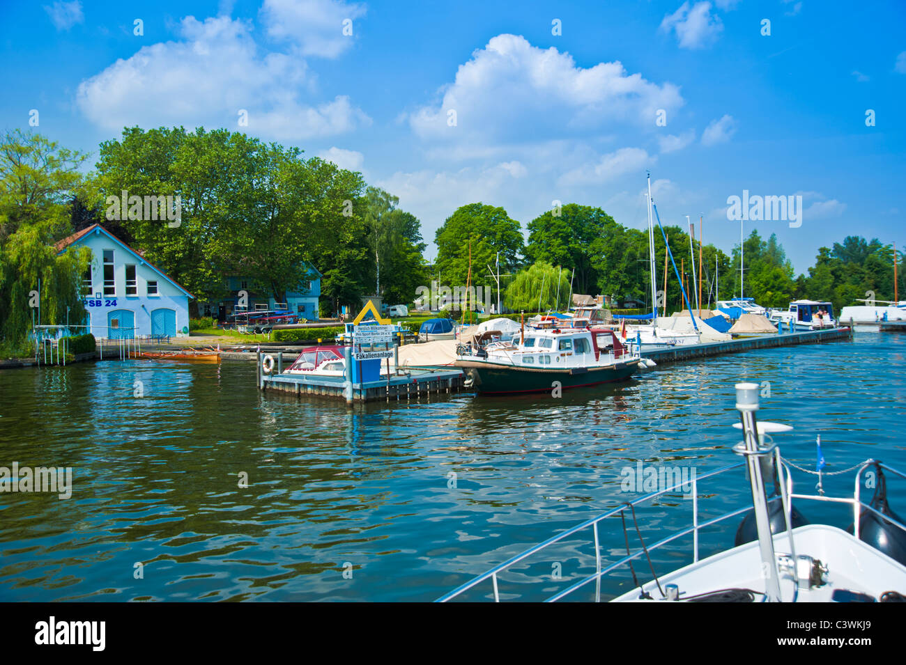 Bow of yacht approaching landing stage at marina, River Dahme, Spree ...