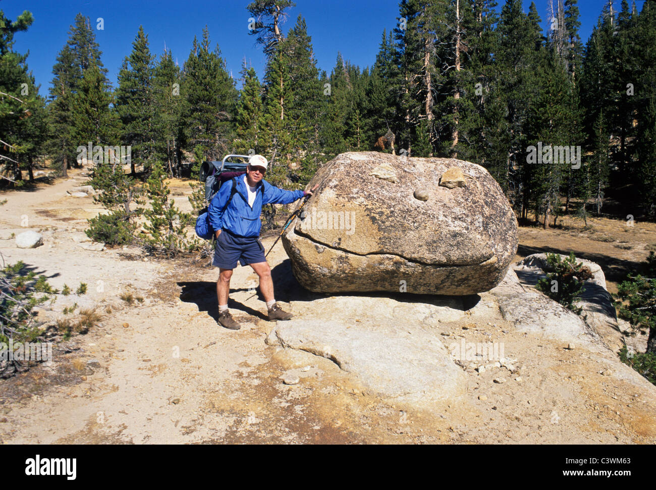 Backpacker by smiling rock Stock Photo - Alamy