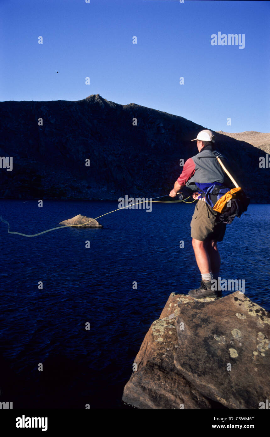 Man casting line into lake Stock Photo - Alamy