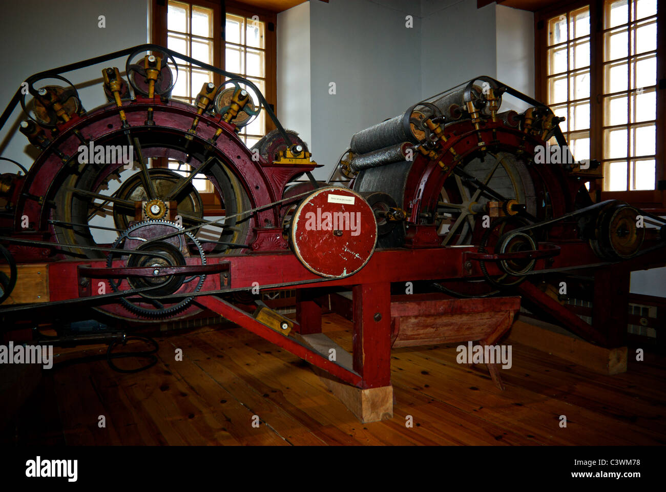 Early powered mechanical wool carding machine in restored textile ...