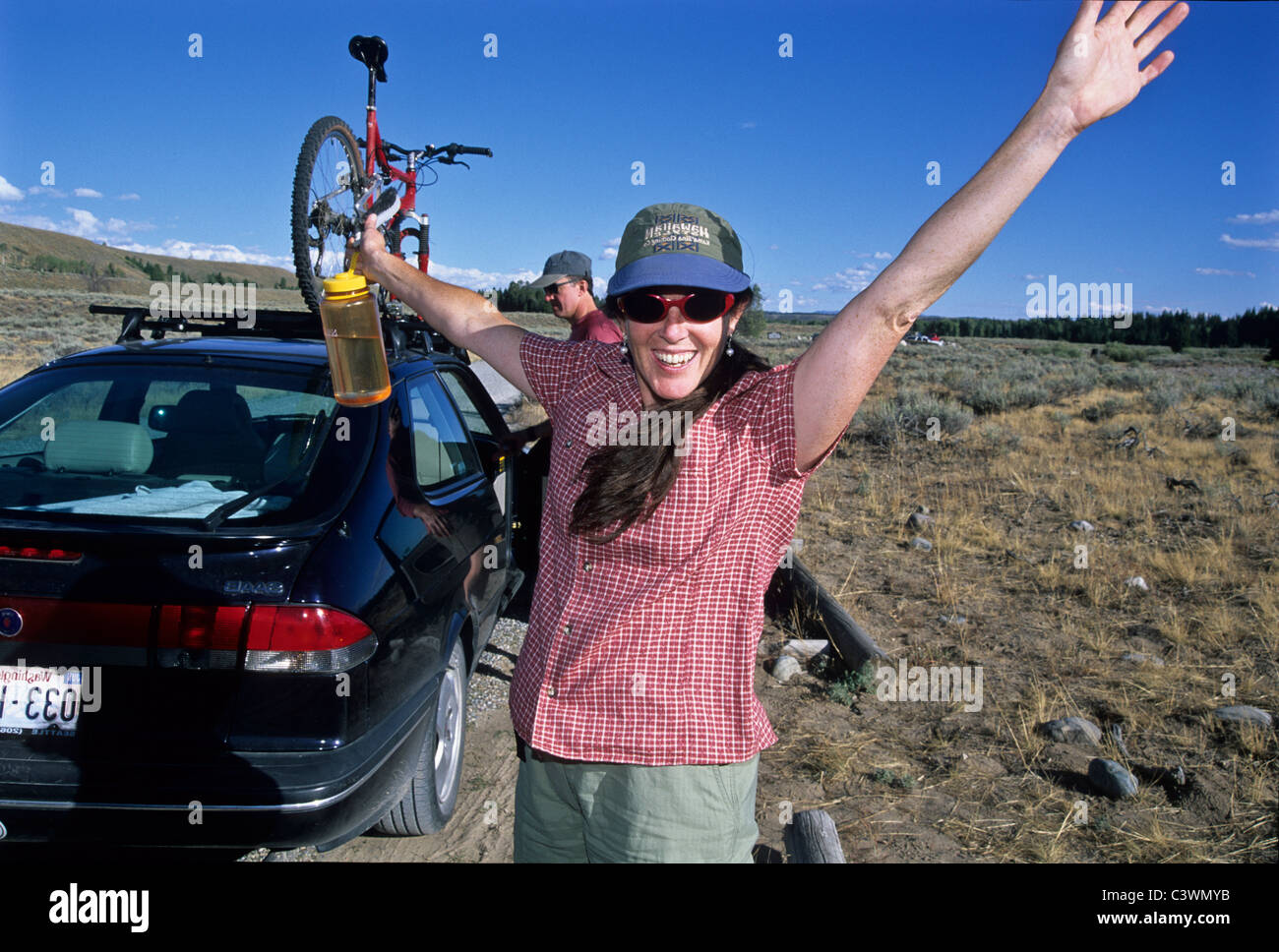 Woman smiling with arms up Stock Photo - Alamy