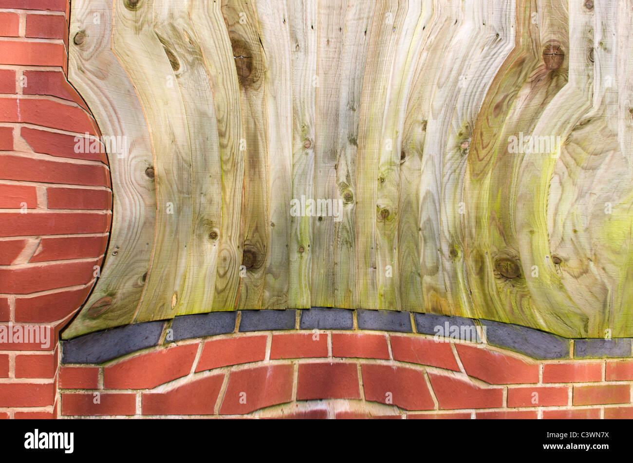 Digitally altered bulging brick wall and fence of stretcher bond ...