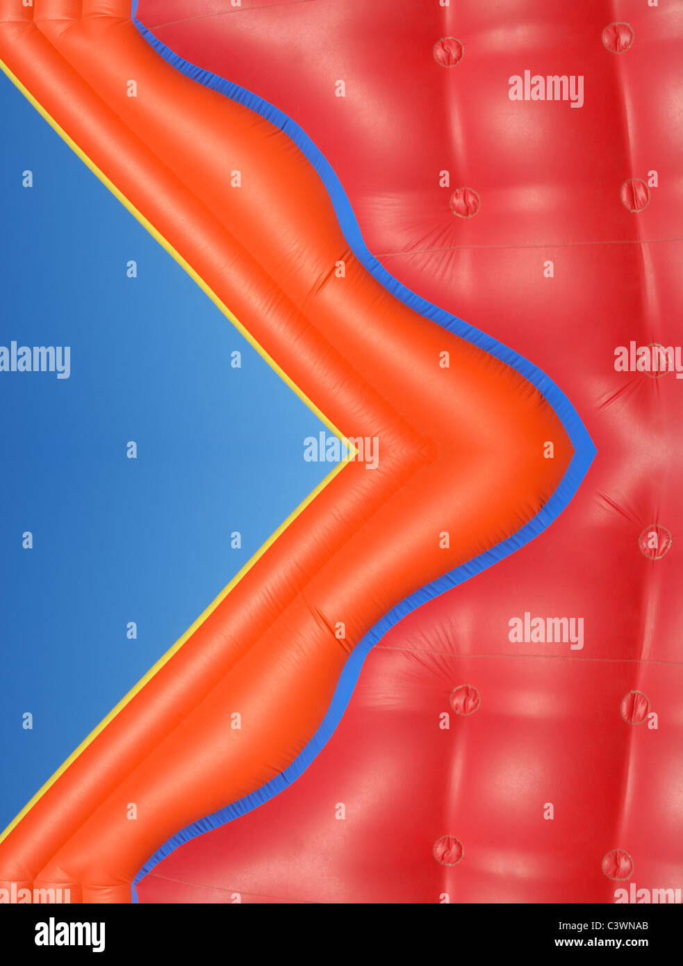 Partial view of a colorful inflatable blow-up toy on blue sky ...