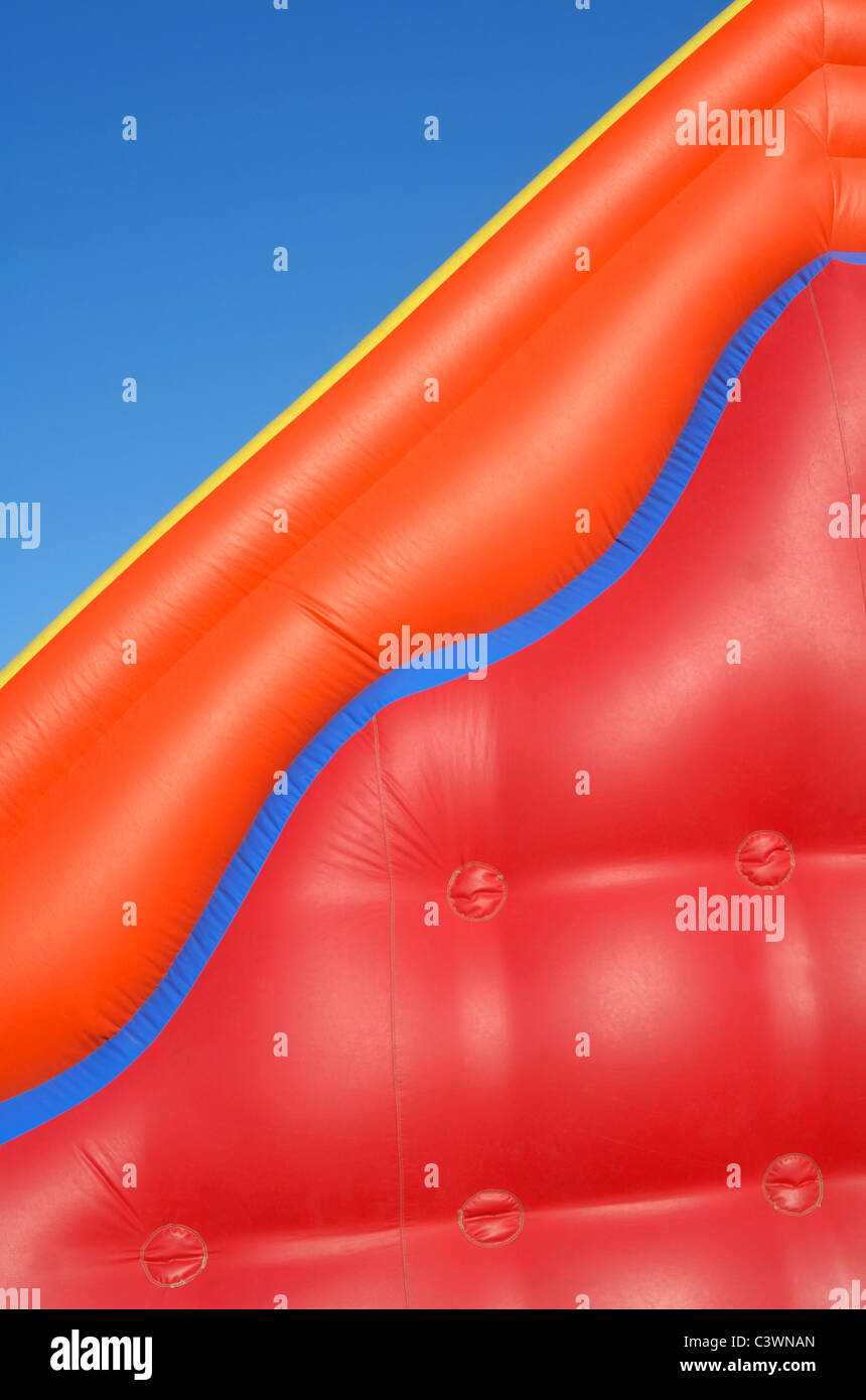 Partial view of a colorful inflatable blow-up toy on blue sky ...