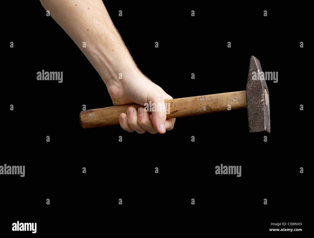 Hammer in a hand isolated on a black Stock Photo - Alamy