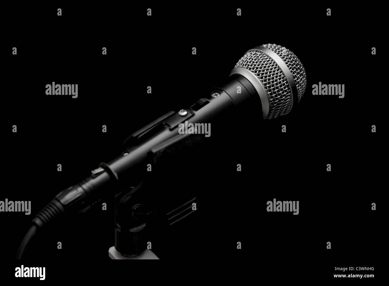 Closeup of a dynamic microphone isolated on black Stock Photo - Alamy