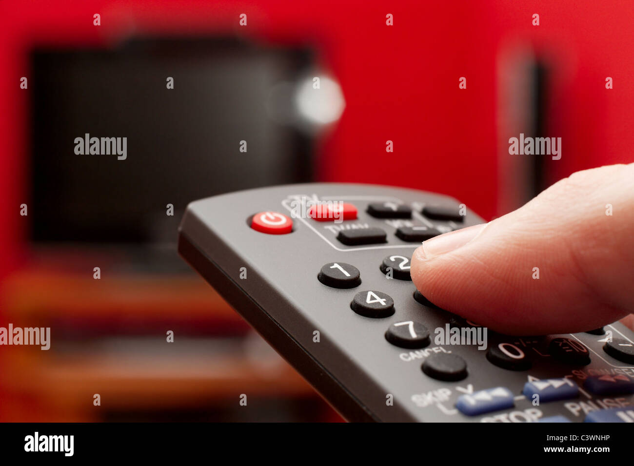 Finger on the remote control of a TV Stock Photo - Alamy