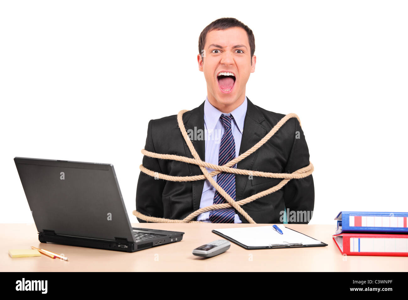 A businessman tied up with rope in the office Stock Photo - Alamy