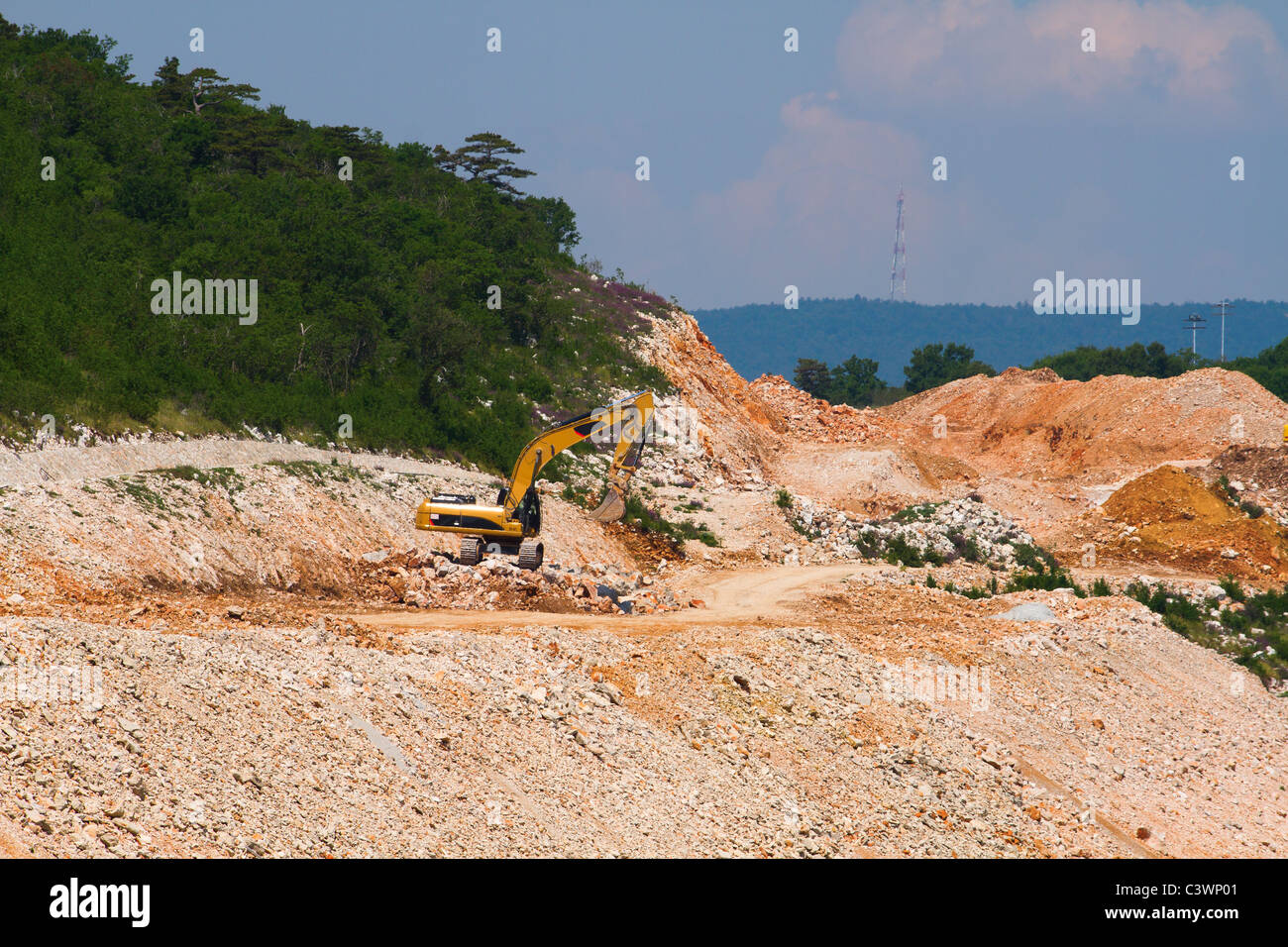 Heavy machine cleaning forest for making new road Stock Photo - Alamy
