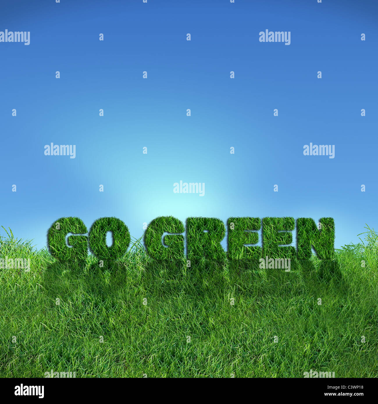 Textured go green sign over fresh grass. Clear blue sky background ...
