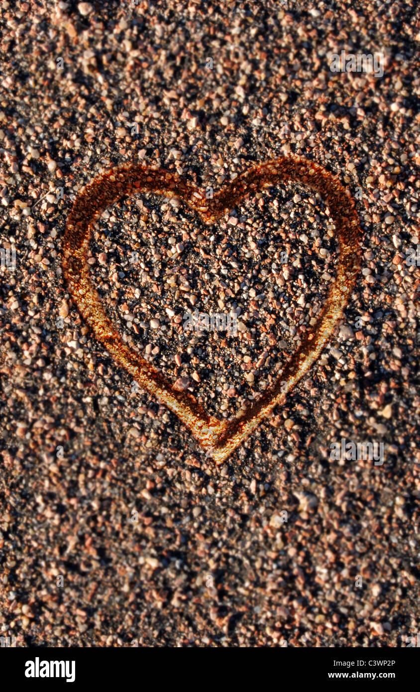 Heart contour on pebbles background Stock Photo - Alamy