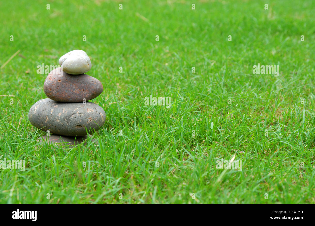 A balance group of zen stones on green grass Stock Photo - Alamy