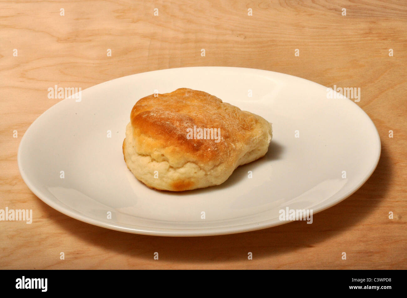 One lone biscuit on a white plate Stock Photo - Alamy