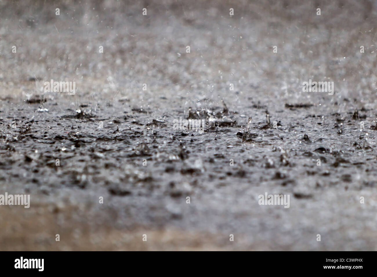 Low Angle View Of Rain Drops Falling On Concrete Stock Photo - Alamy