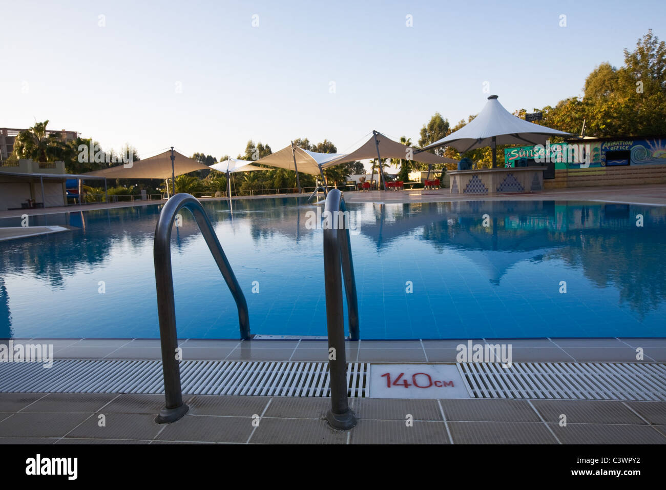 Swimming pool in early morning, beach bar on background Stock Photo - Alamy