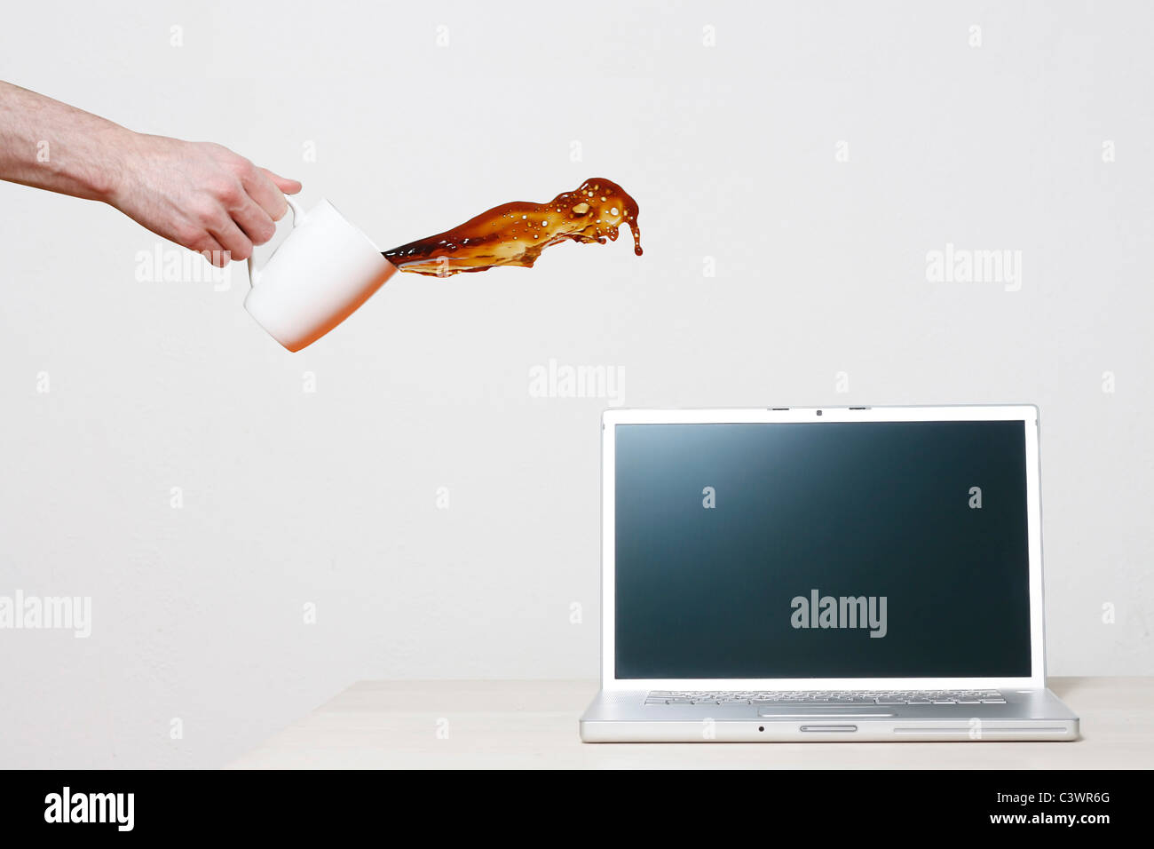 Accidentally pouring coffee on a laptop Stock Photo - Alamy