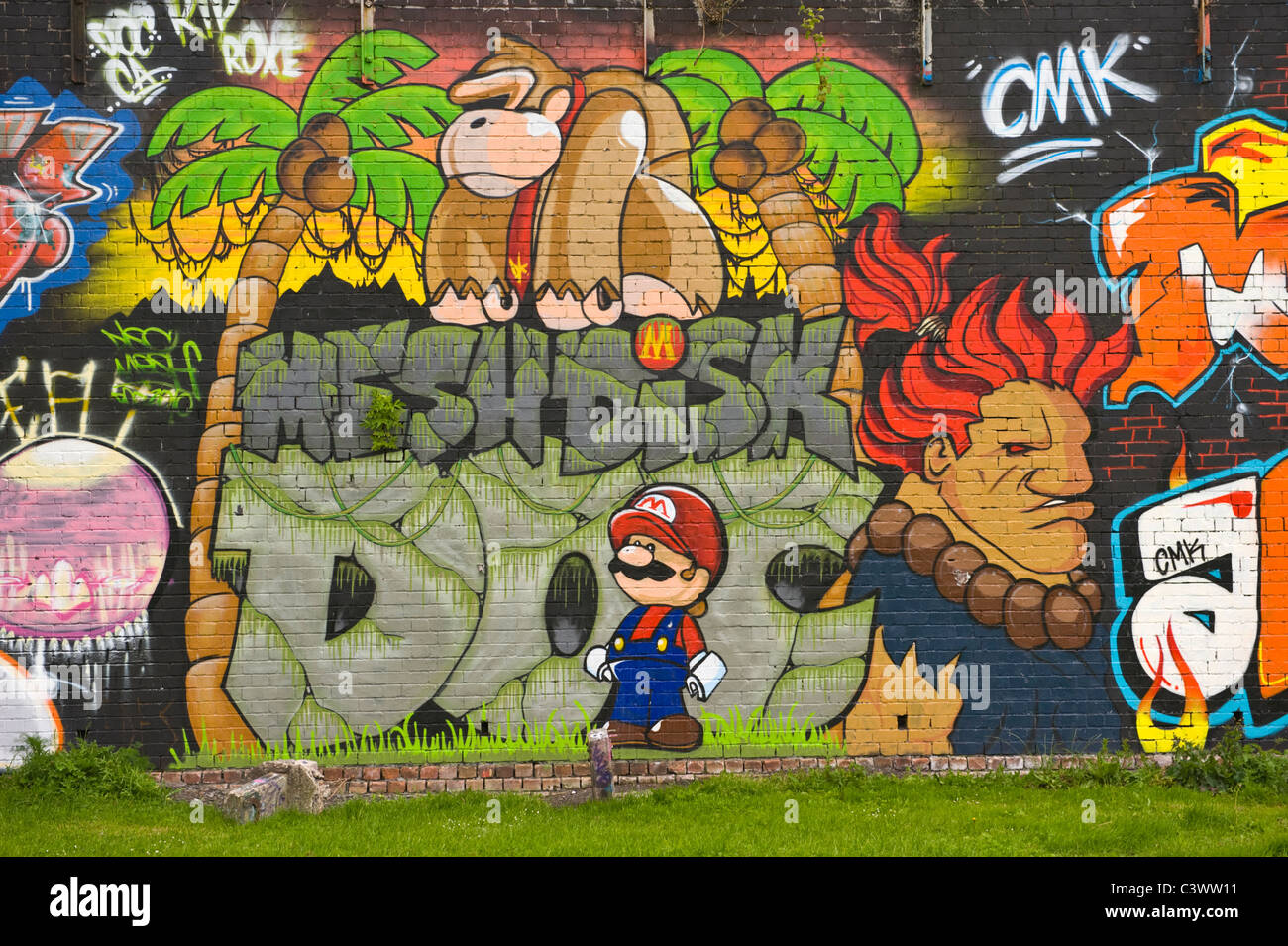 Urban graffiti artwork of MARIO on brick wall of railway embankment in ...
