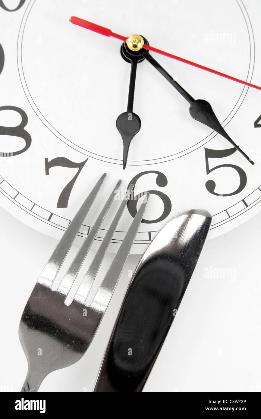 fork and wall clock with white background, concept of dinner time Stock ...