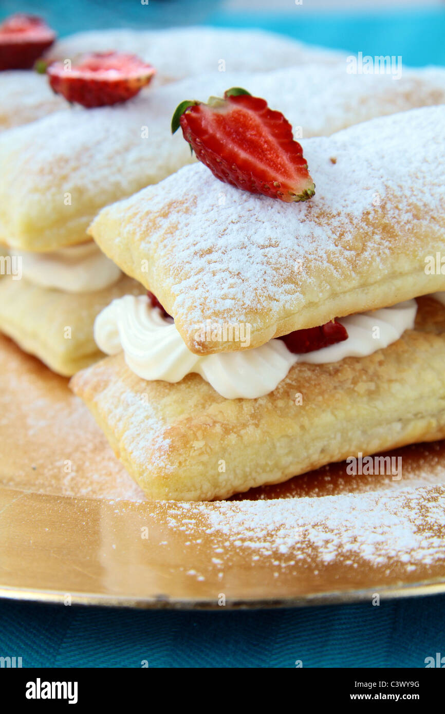 dessert cake of puff pastry, whipped cream and strawberries Stock Photo ...